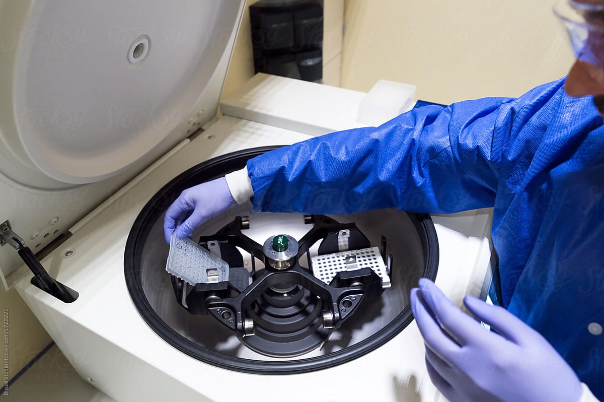 "Biologist Putting A Multy Well Tray Into Centrifuge" by Stocksy ...