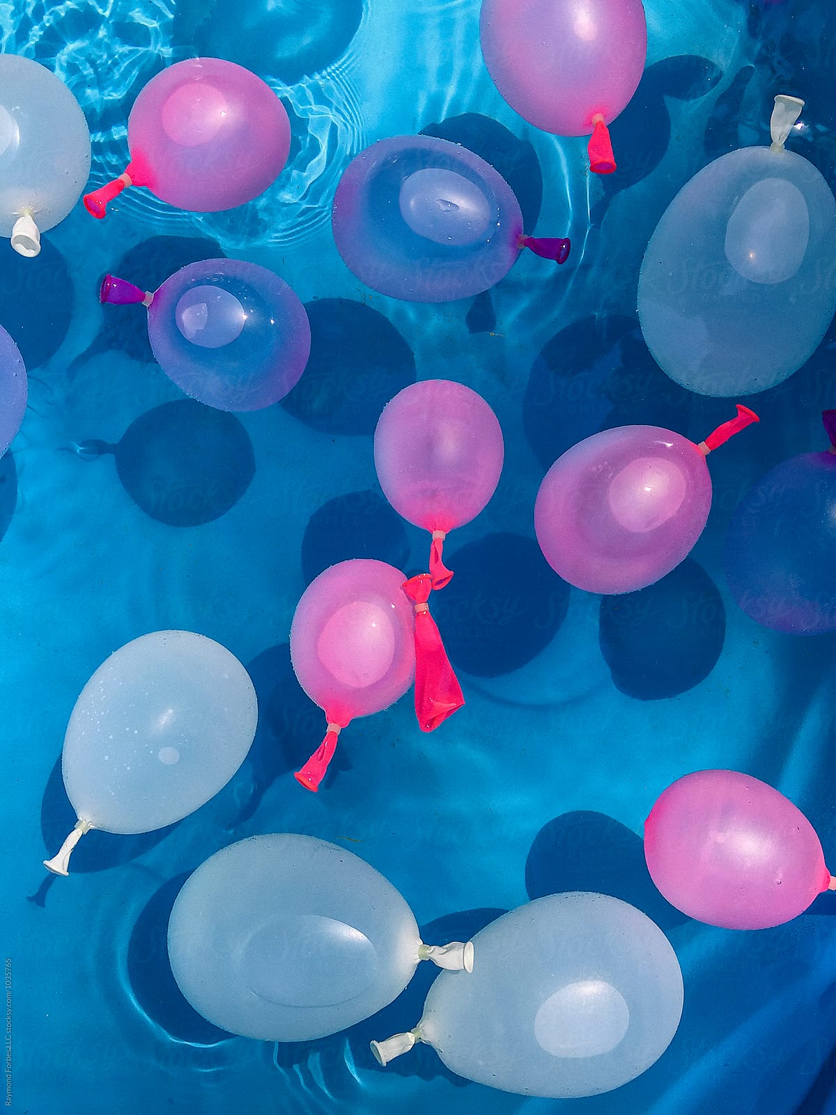"Water Balloons" by Stocksy Contributor "Raymond Forbes LLC" - Stocksy