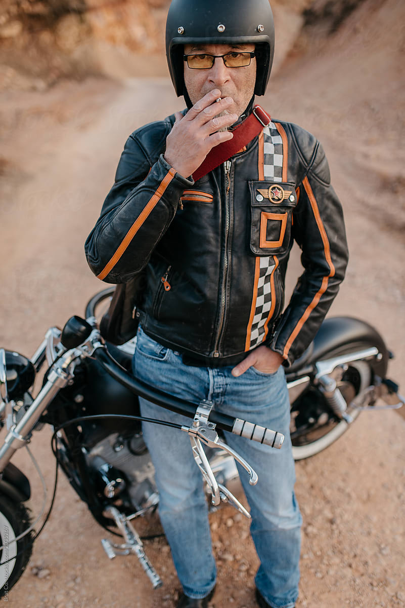 "Senior Biker Smoking" by Stocksy Contributor "Brat Co" - Stocksy