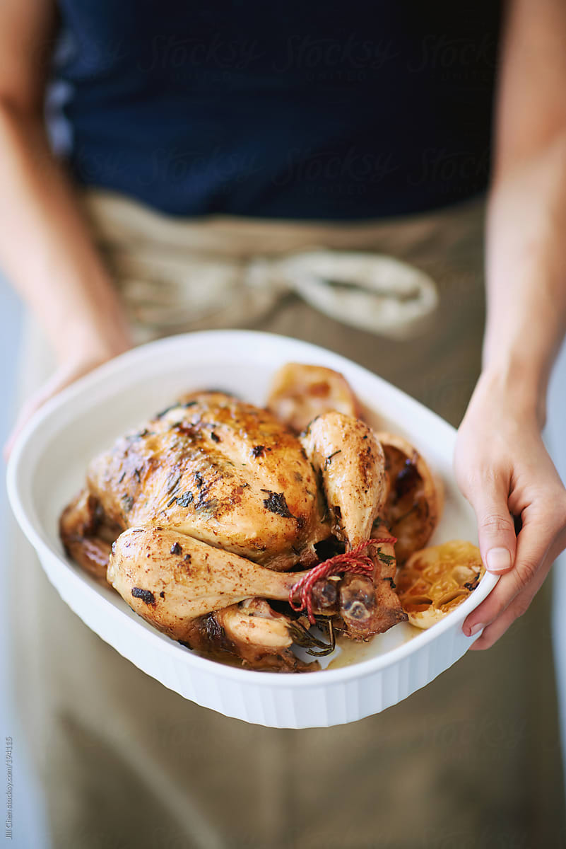 "Woman Holding A Whole Roast Chicken" by Stocksy Contributor "Jill Chen ...