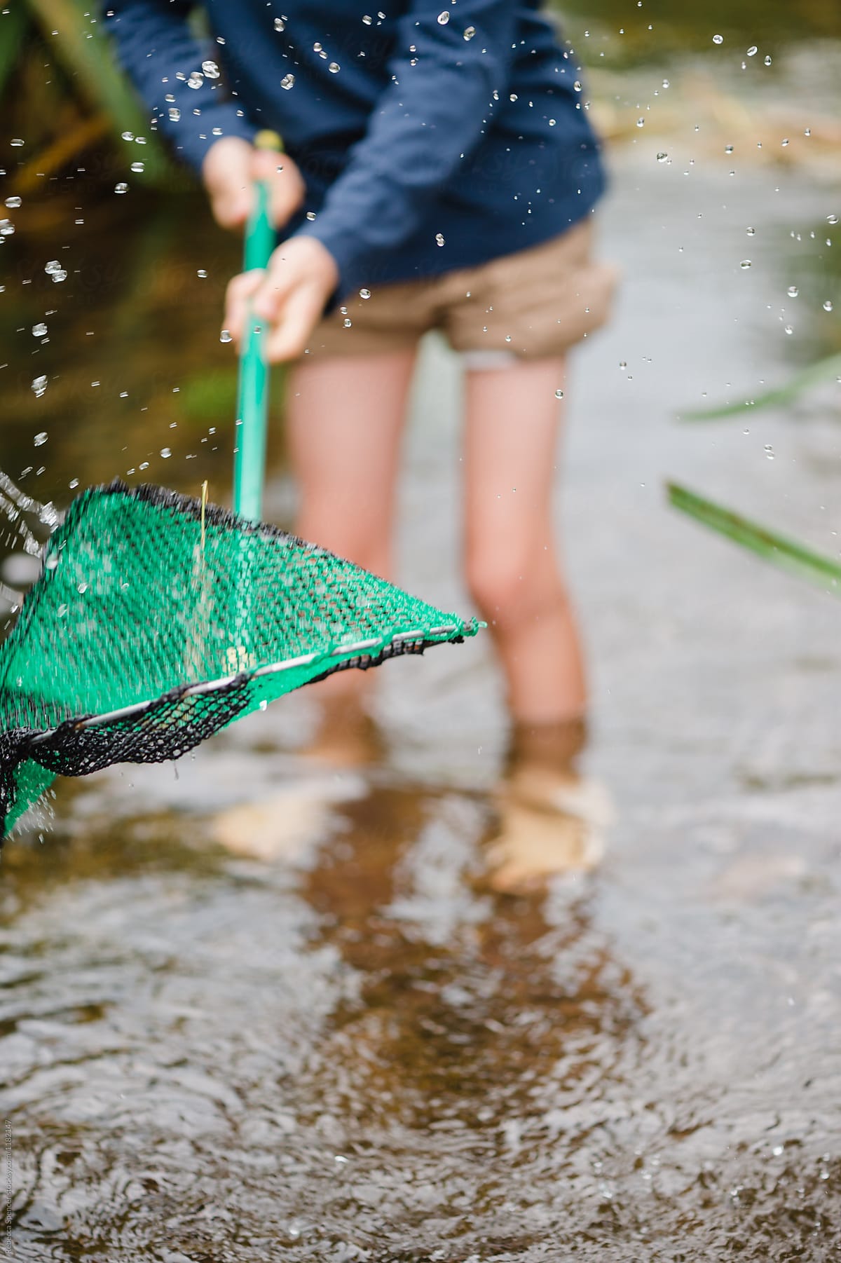 "Child Trying To Catch Fish With A Fishing Net" by Stocksy Contributor ...