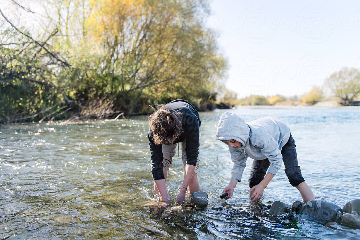 "Two Kids Playing Together In A River" by Stocksy Contributor "Angela ...