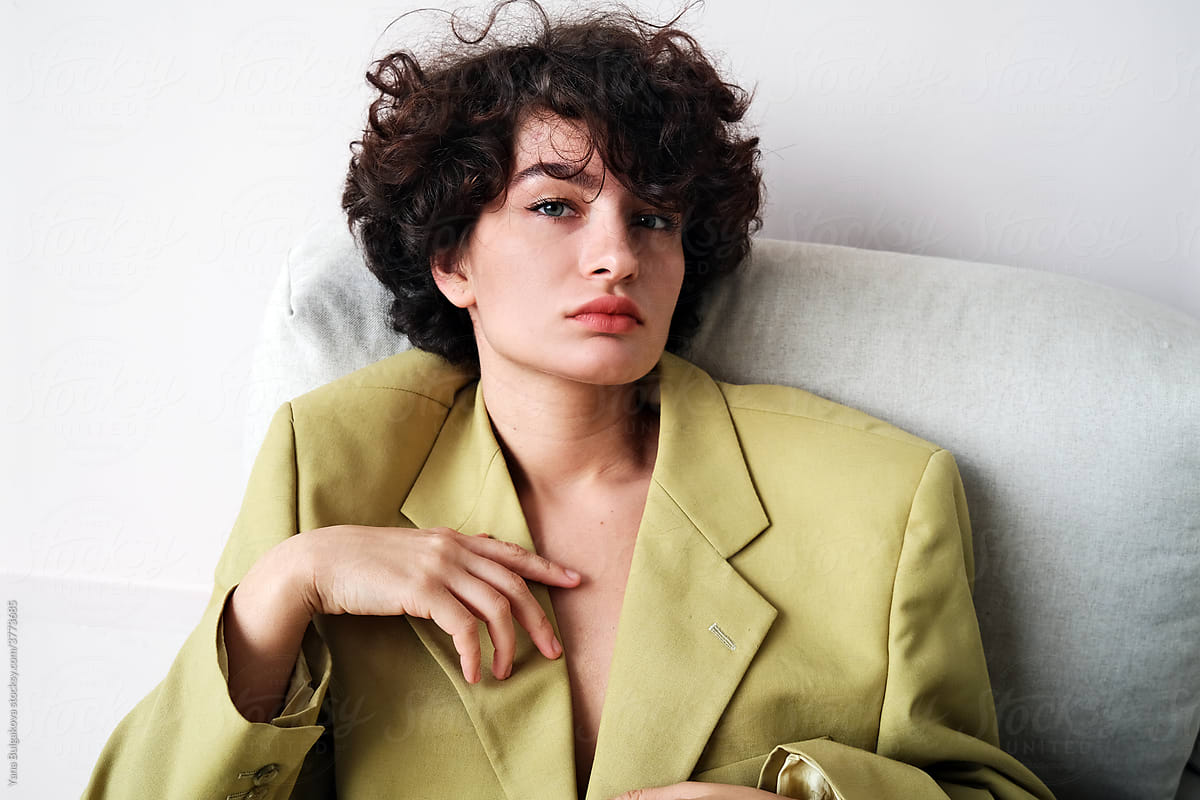 "Curly Girl Sitting On Couch" by Stocksy Contributor "Yana Bulgakova ...