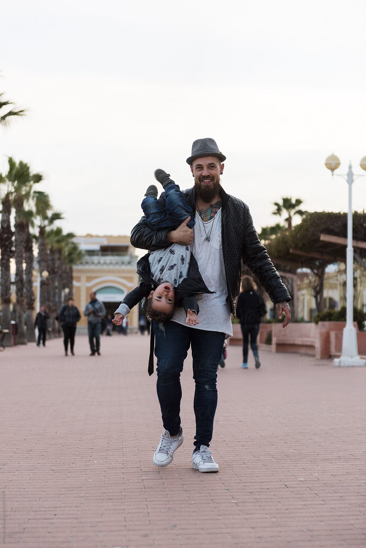 "Man Carrying Boy Upside Down" by Stocksy Contributor "Milles Team ...