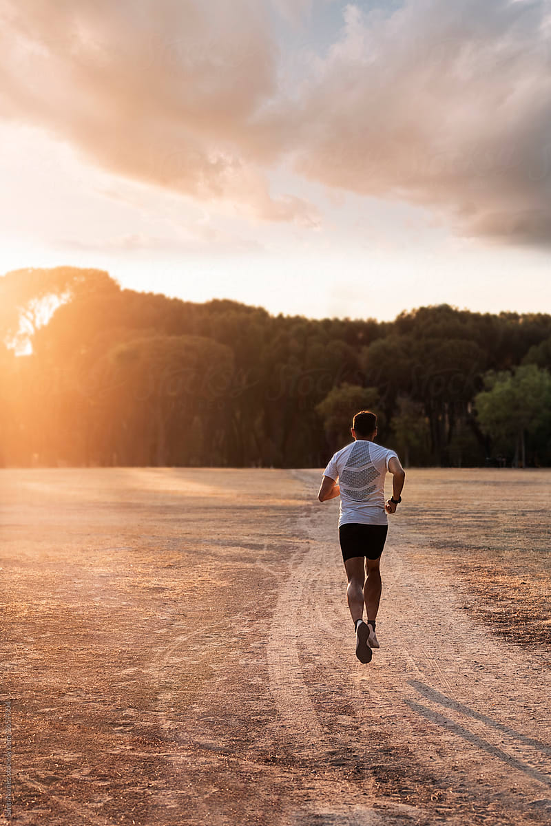 "Unrecognizable Man Running In The Park" by Stocksy Contributor "Santi ...