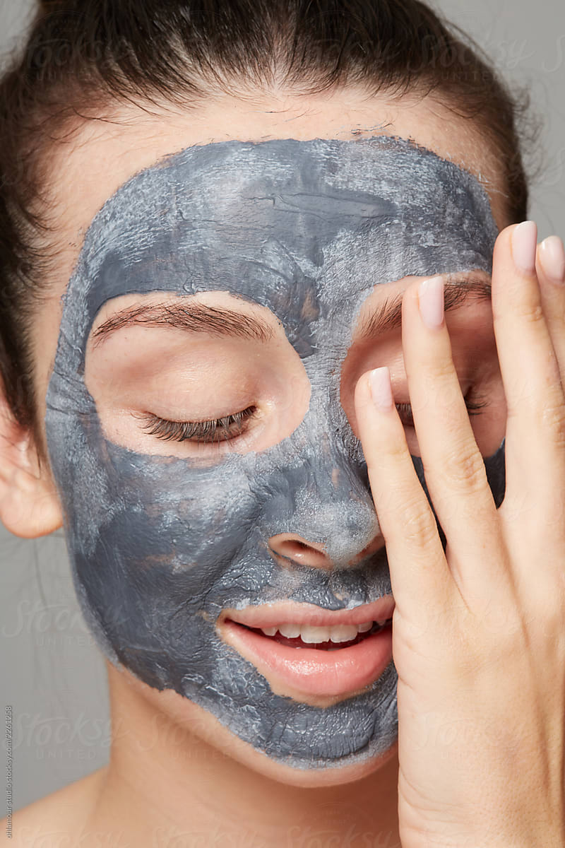 "Woman Aplying Clay Mask" by Stocksy Contributor "Leandro Crespi" - Stocksy