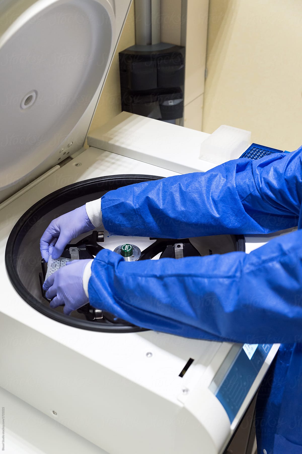 "Biologist Putting A Multy Well Tray Into Centrifuge" by Stocksy ...