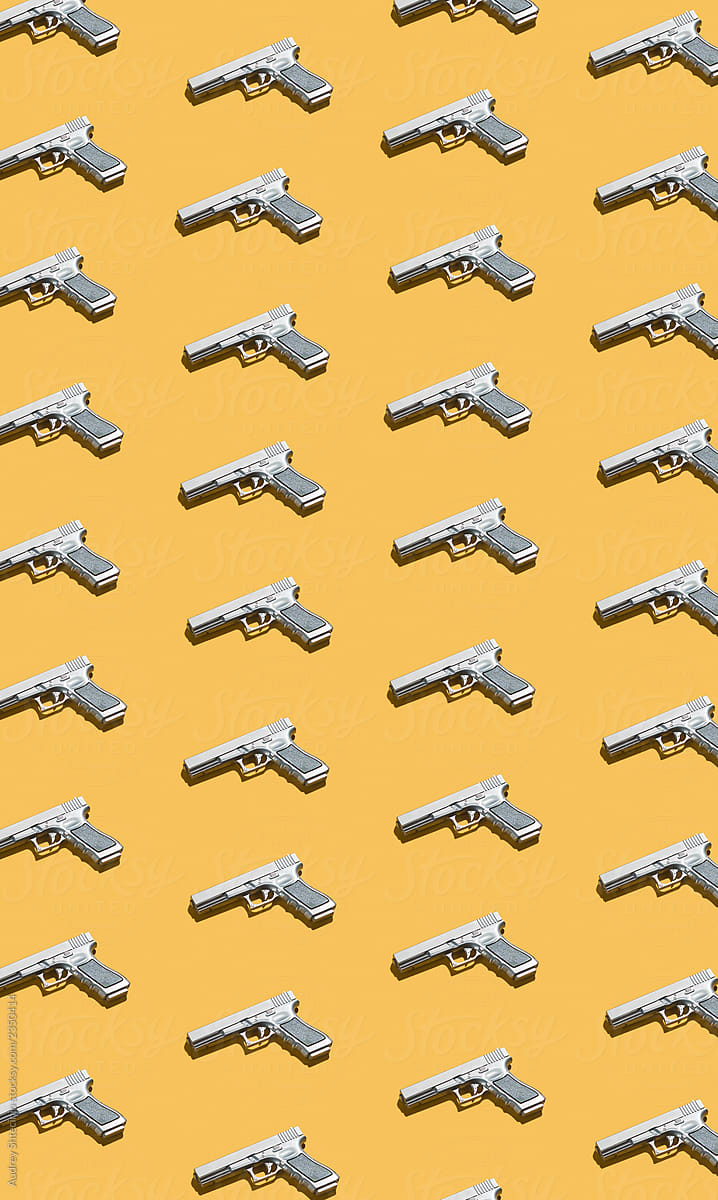 "Gun On Yellow" by Stocksy Contributor "AUDSHULE" - Stocksy