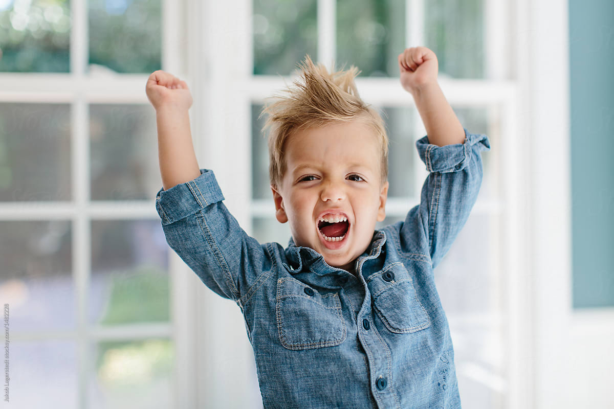"Cute Young Boy With Wild Hair Screaming With His Arms Up" by Stocksy ...