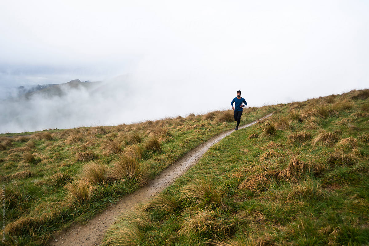 Man cross country running in the mountains. - Stock Image - Everypixel