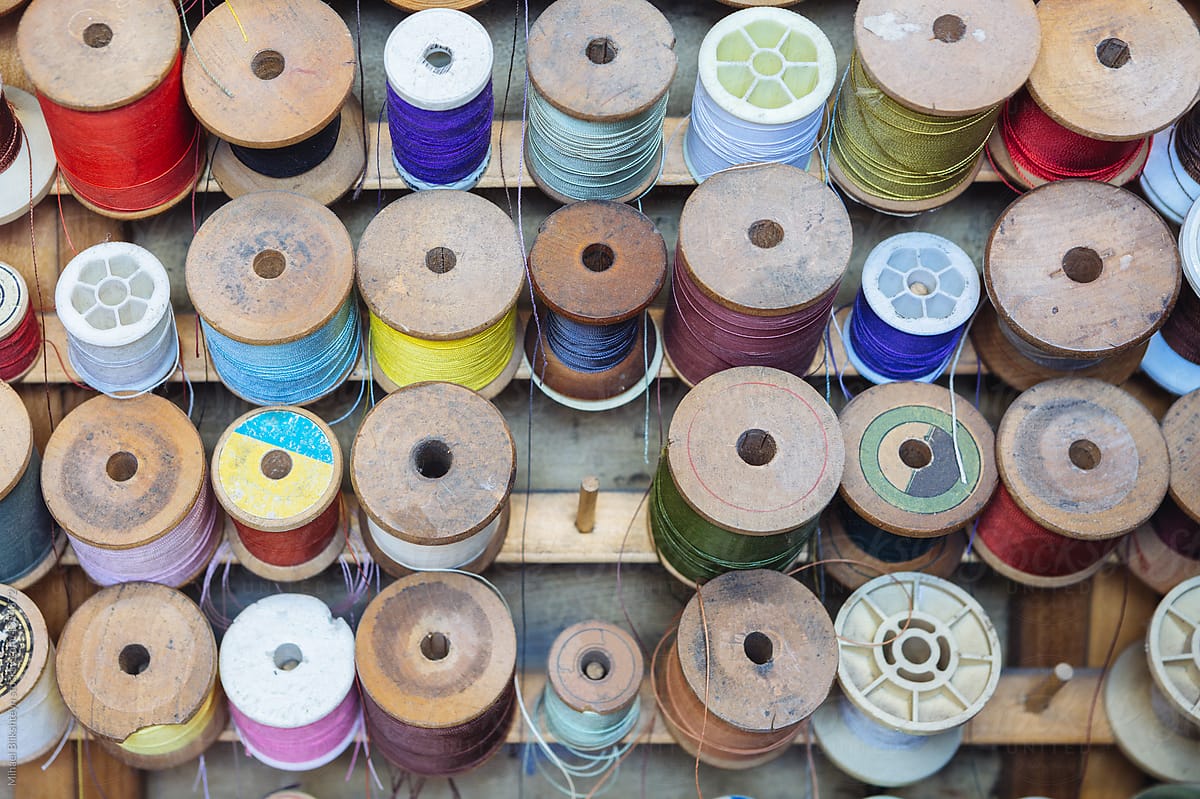 "Colored Sewing Spools Of Threads On A Rack" by Stocksy Contributor ...