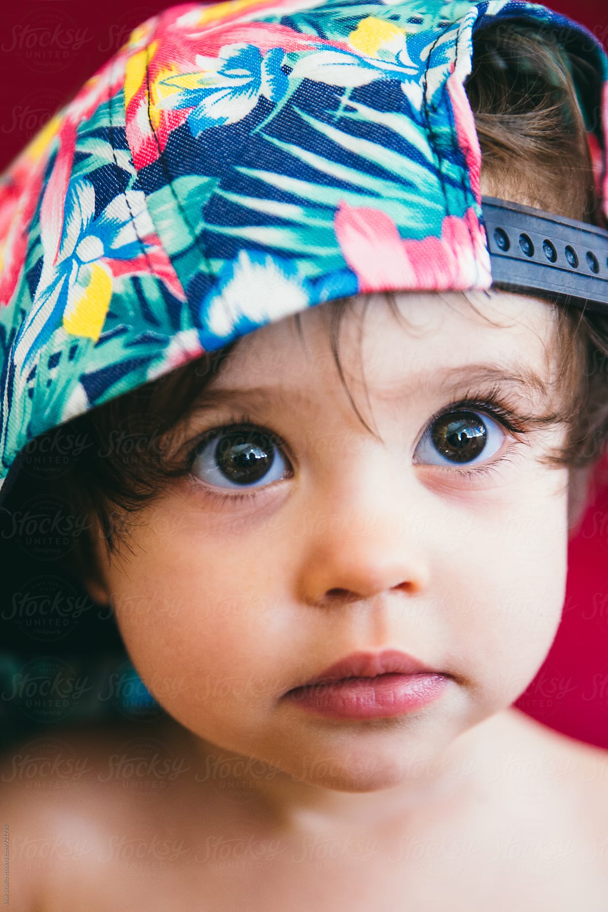 "Stylish Baby Wearing A Colourful Flower Cap" by Stocksy Contributor ...