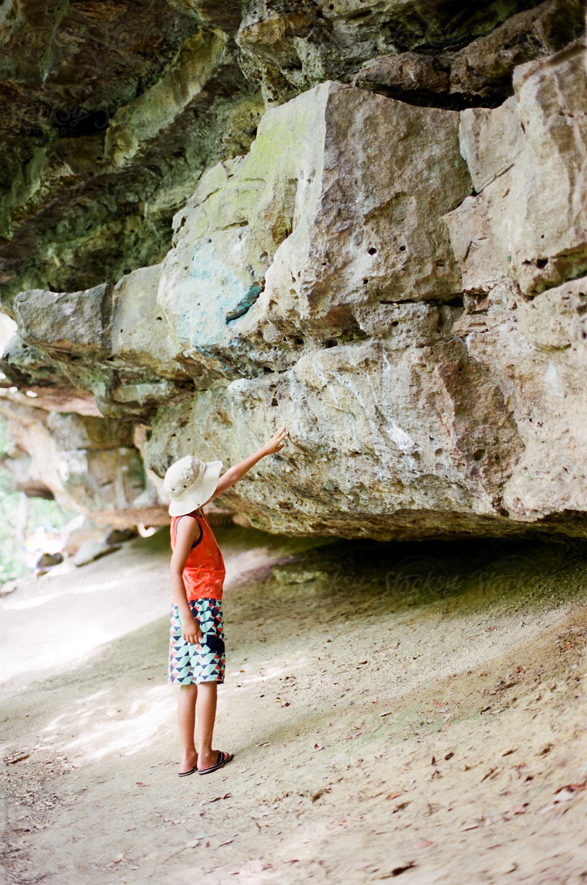 "Boy Looking At A Large Rock Wall" by Stocksy Contributor "Marta ...