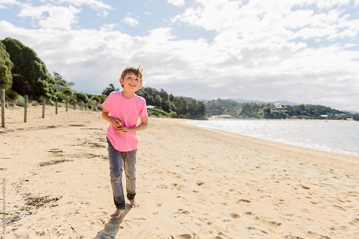 "Happy Boy Running Along A Golden Sand Beach In New Zealand" by Stocksy ...