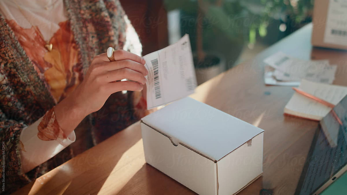 "Woman Applying Shipping Label On Box" by Stocksy Contributor "Milles ...