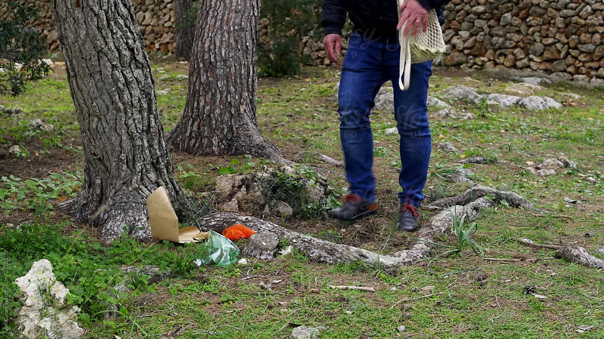 "Man Cleaning Up Litter In A Park" by Stocksy Contributor "Ivan Gener ...