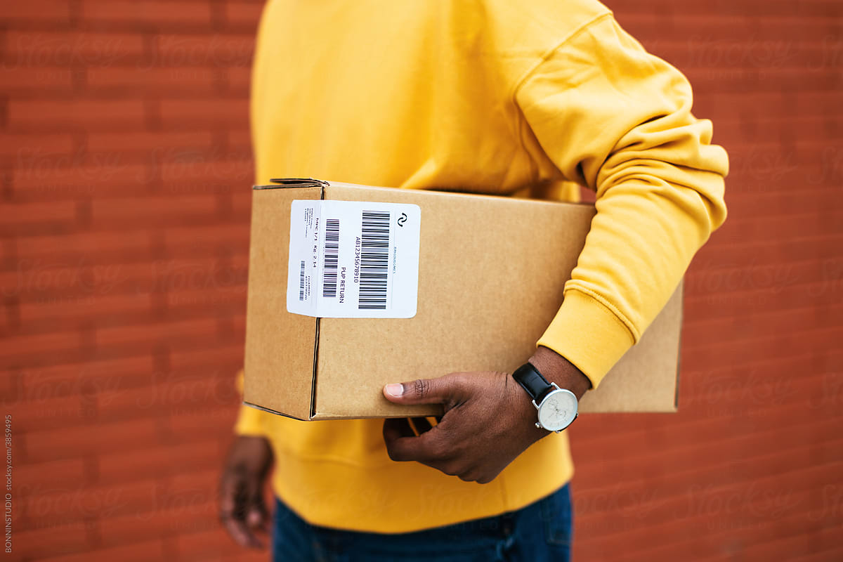 "Crop Courier With Carton Box In Street" by Stocksy Contributor ...