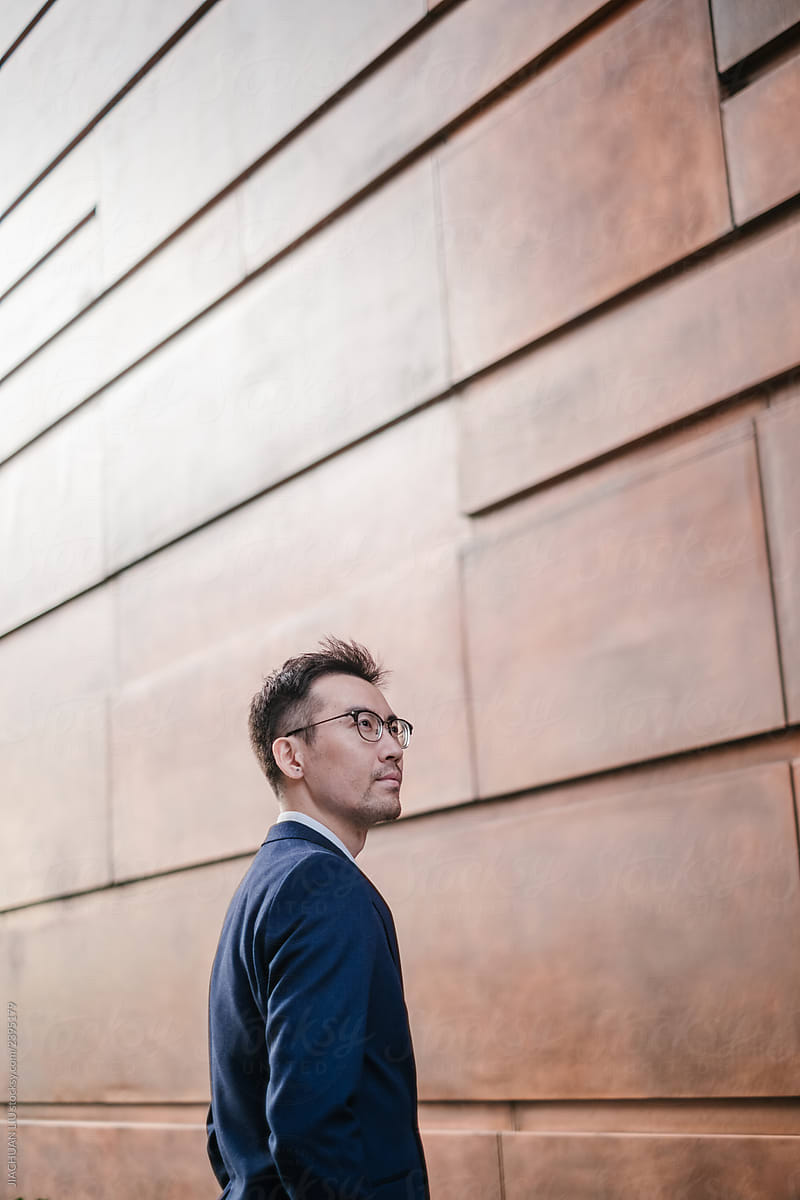 "Business Man Standing In Front Of A Brown Wall" by Stocksy Contributor ...