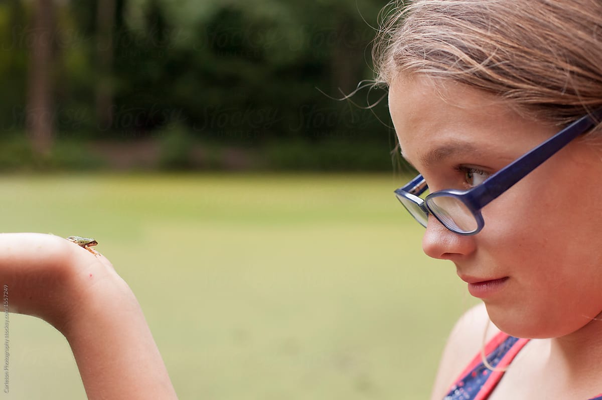 "Holding A Tree Frog" by Stocksy Contributor "John Carleton" - Stocksy
