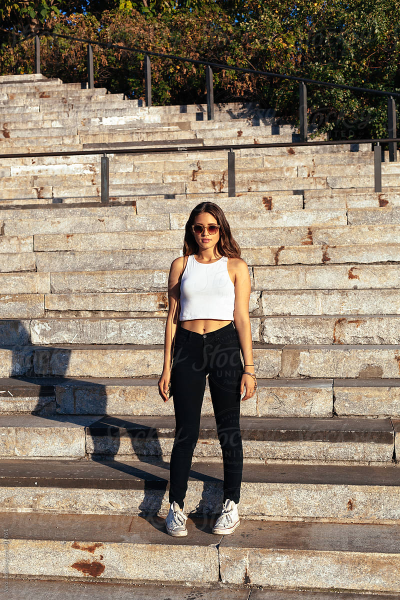 "Cool Woman Standing On Steps" by Stocksy Contributor "Vero." - Stocksy