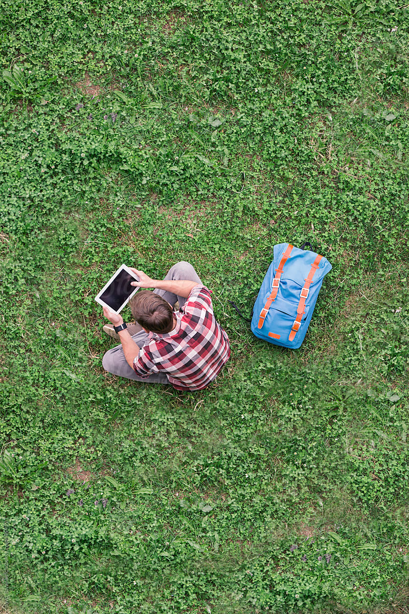 "Overhead View Of Young Man In The Park Using An Ipad" by Stocksy ...