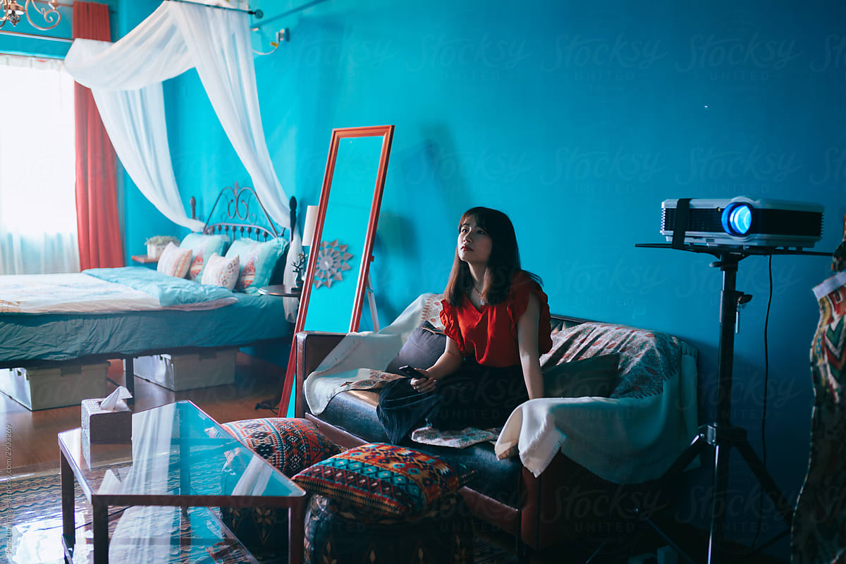 "Asian Woman Watch Projected Movie At Home" by Stocksy Contributor ...