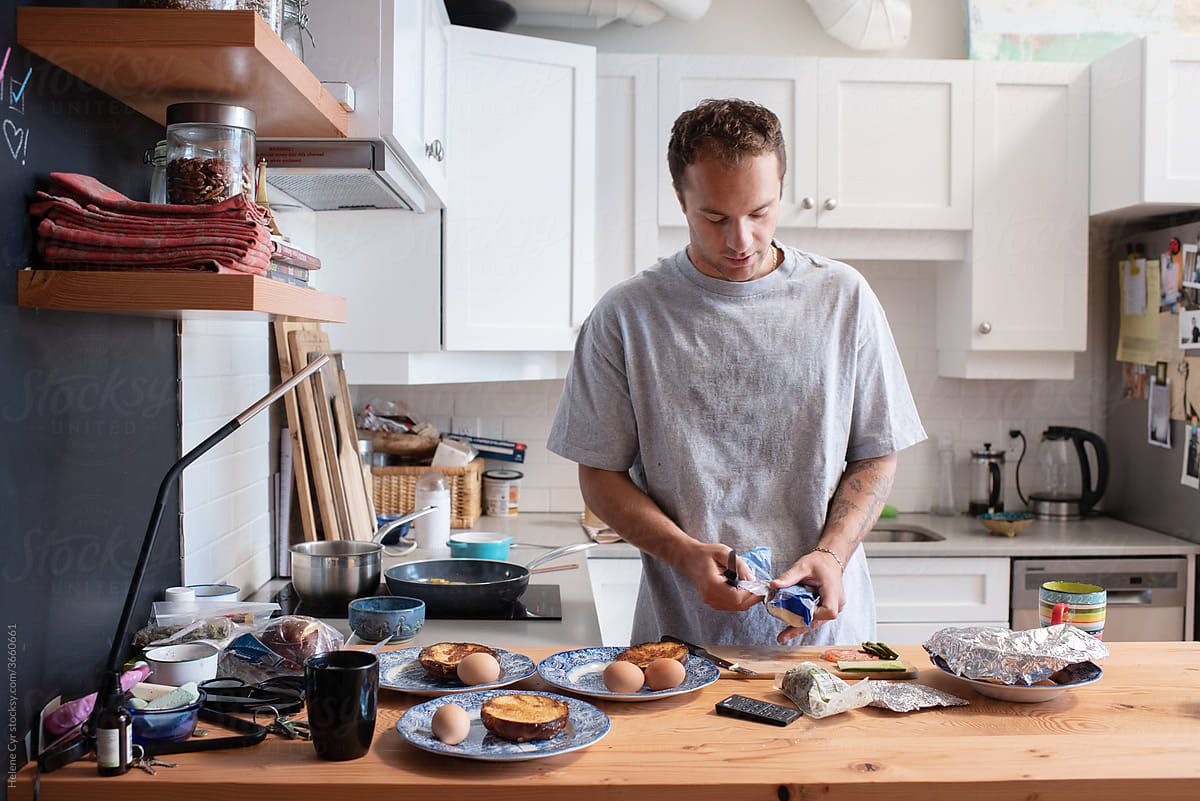 "Man Prepping Food" by Stocksy Contributor "Helene Cyr" - Stocksy