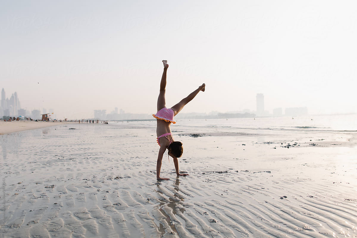 "A Girl Doing A Somersault On The Beach" by Stocksy Contributor ...