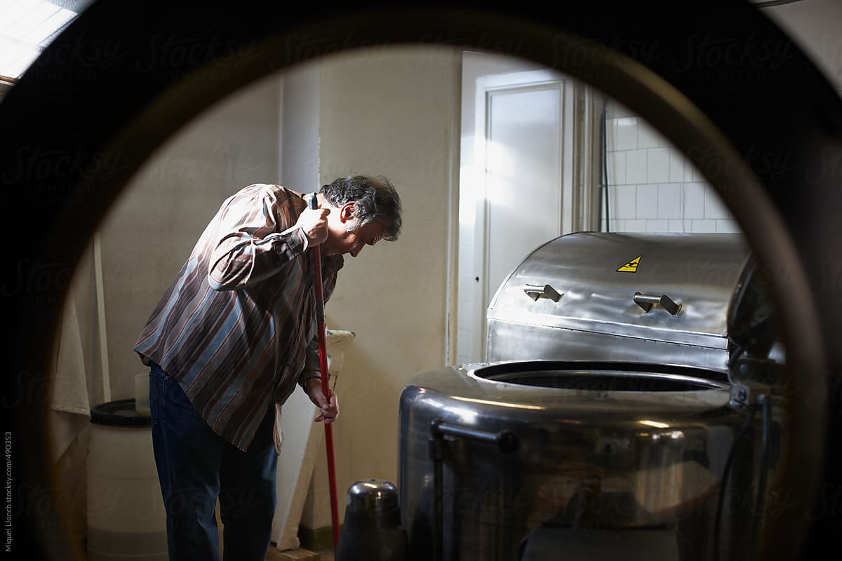 "Mature Man Mopping The Floor Of The Laundry In A Textile Workshop" by ...