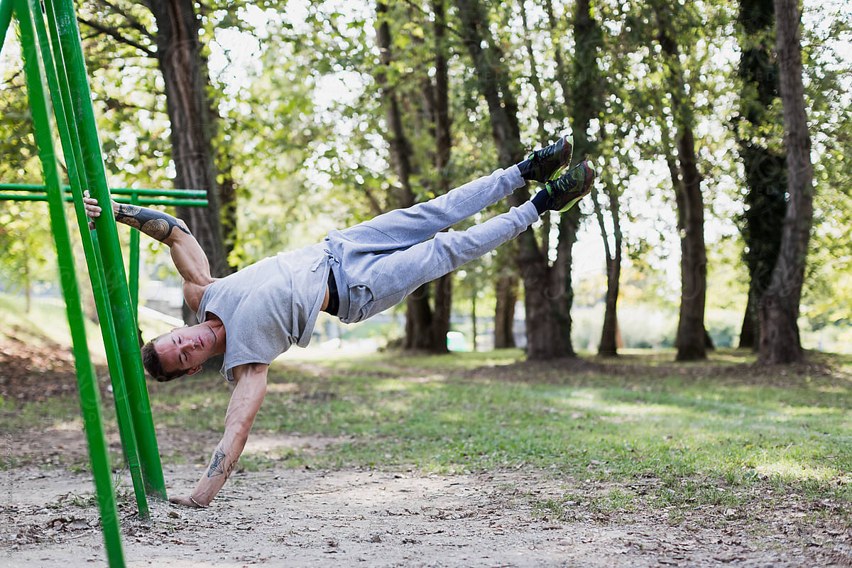 "Man Doing Human Flag" by Stocksy Contributor "Mauro Grigollo" - Stocksy