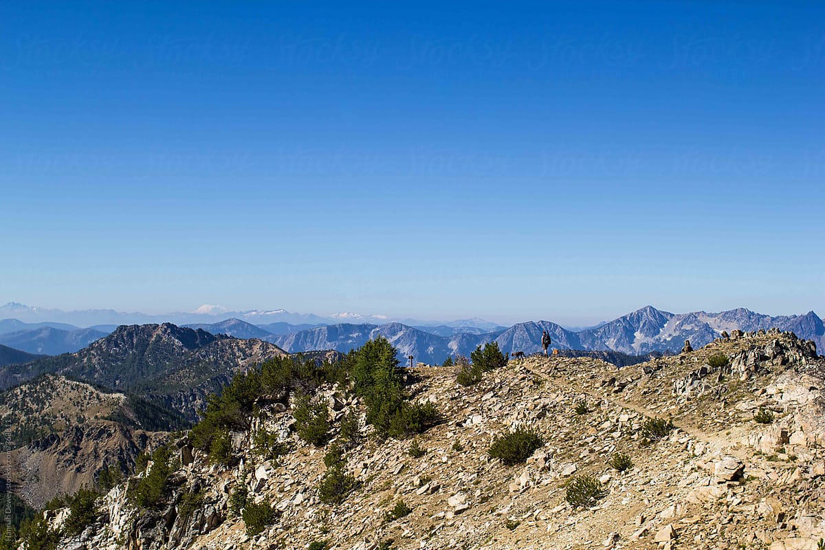 "Man Hikes In The Far Distance In The North Cascade Mountain Range" by ...
