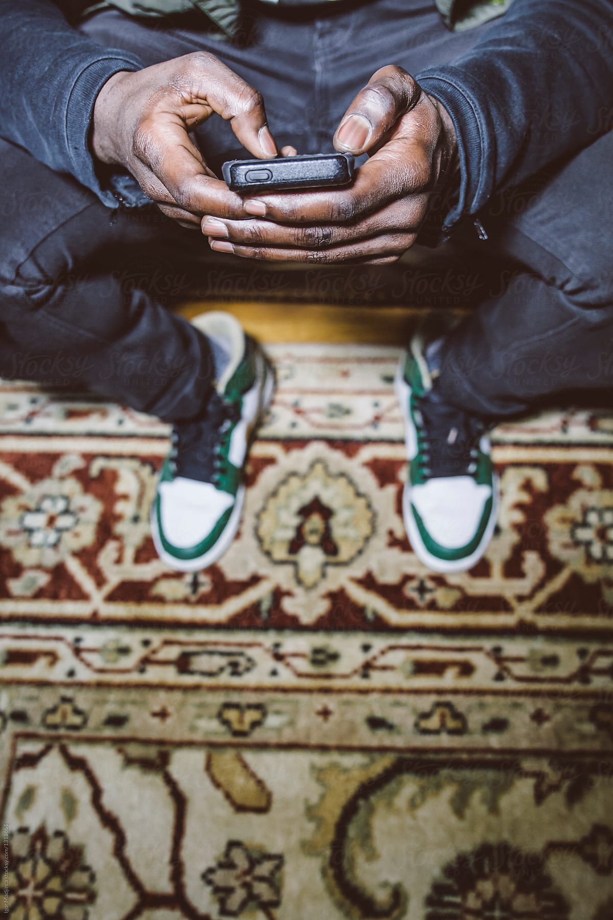 "A BLACK MAN IS SENDING A MESSAGE FROM A MOBILE PHONE" by Stocksy ...