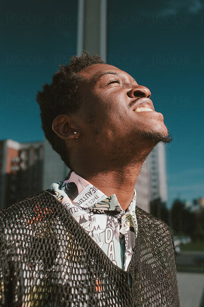 "Smiling Black Man In Sunlight" by Stocksy Contributor "Serge Filimonov ...