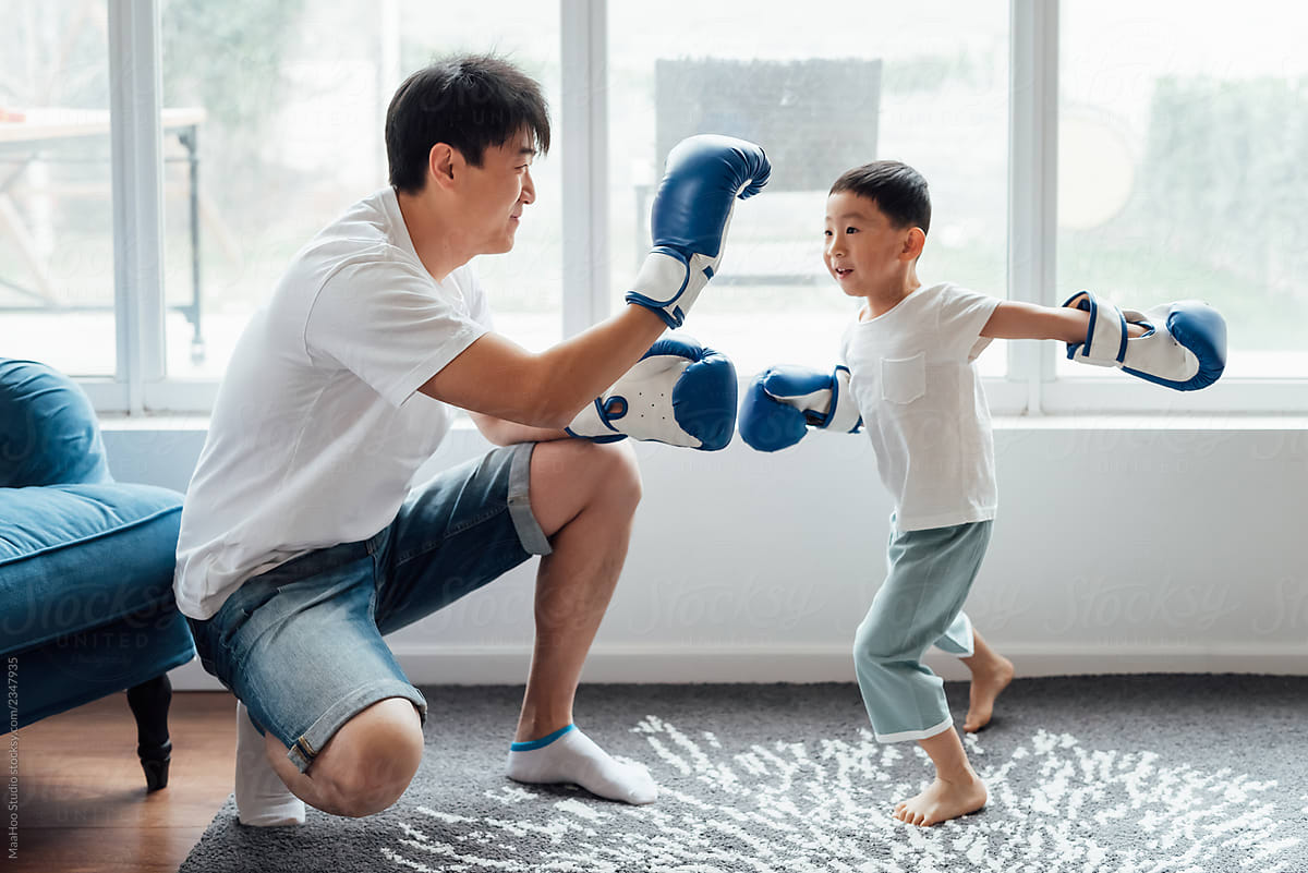 "Father And Son Boxing At Home" by Stocksy Contributor "MaaHoo" - Stocksy