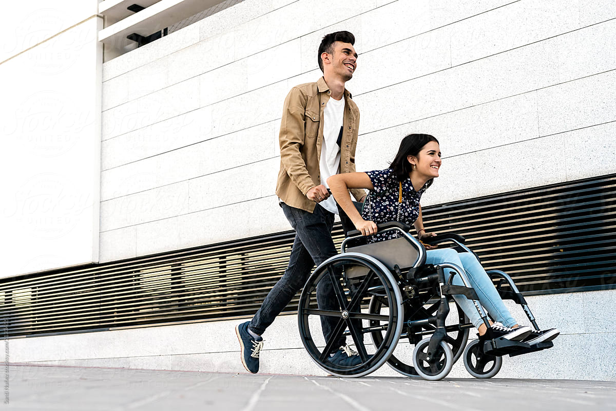 "Man Pushing Woman In Wheelchair Outdoors" by Stocksy Contributor ...