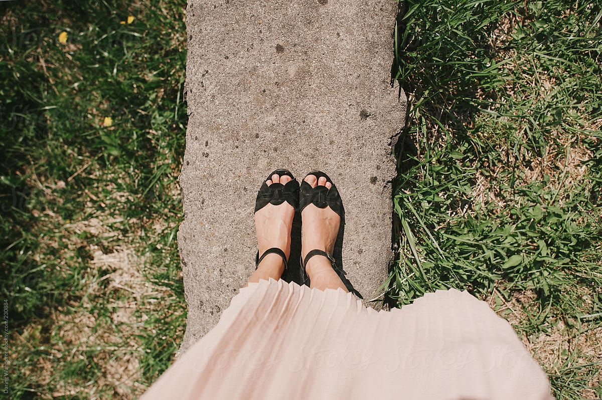 "Girl Standing On Ruin Wall Looking Down At Feet" by Stocksy ...