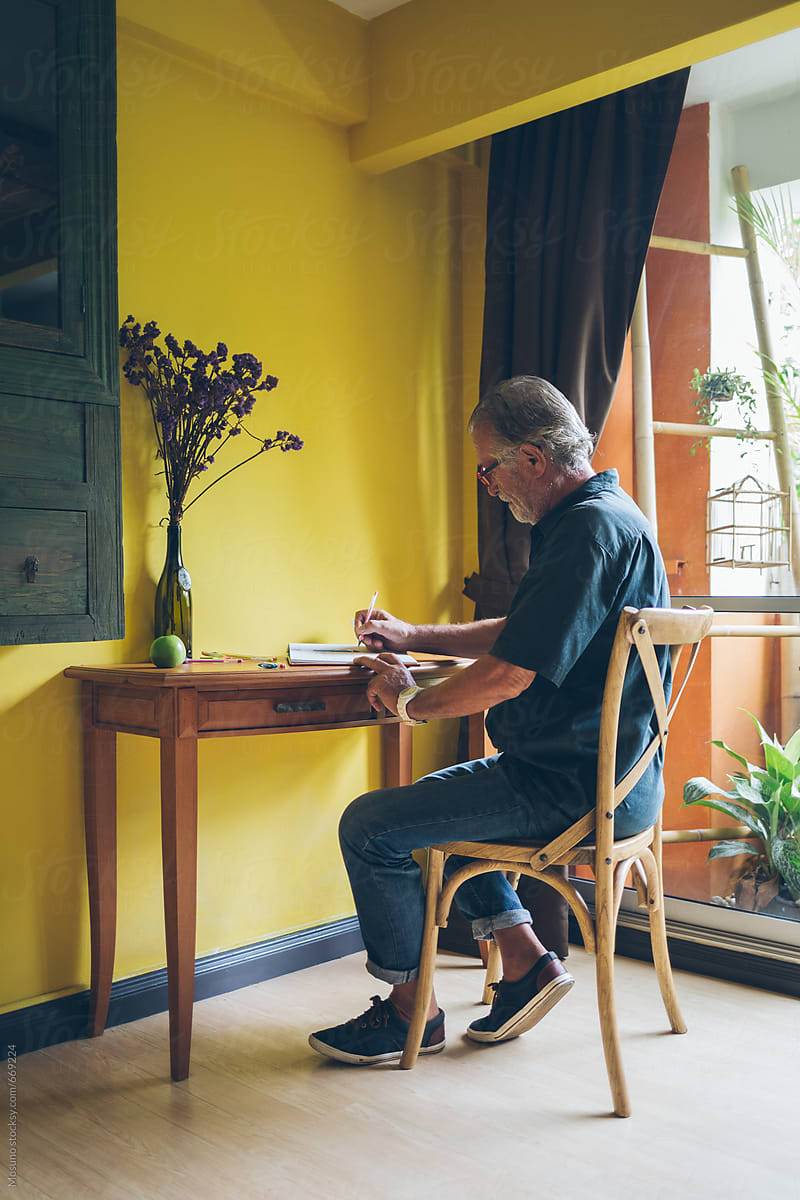 "Senior Man Writing In His Diary At Home" by Stocksy Contributor ...