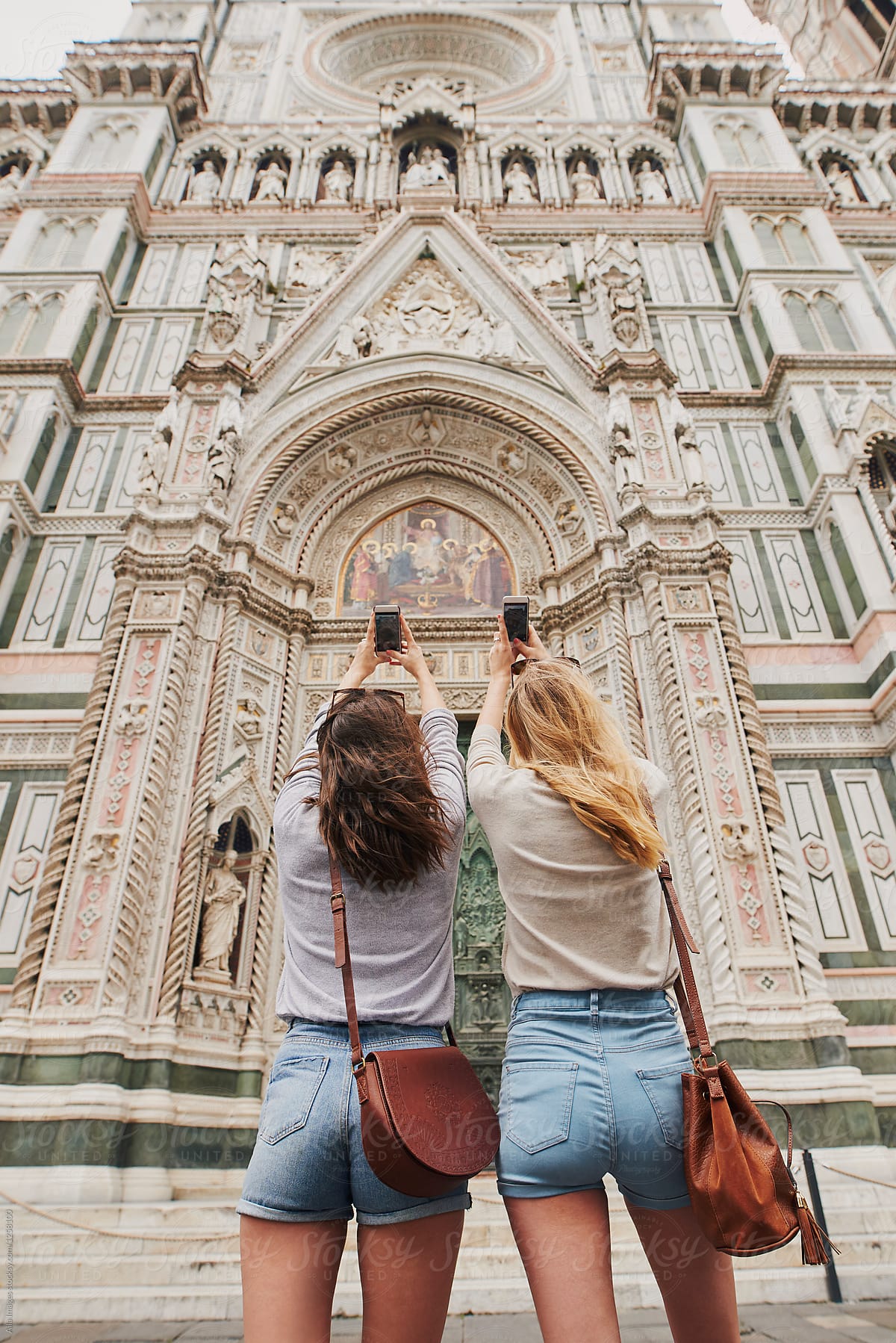 "Two Girl Friends Photograph Architecture Buildings With Smart Ph" by ...