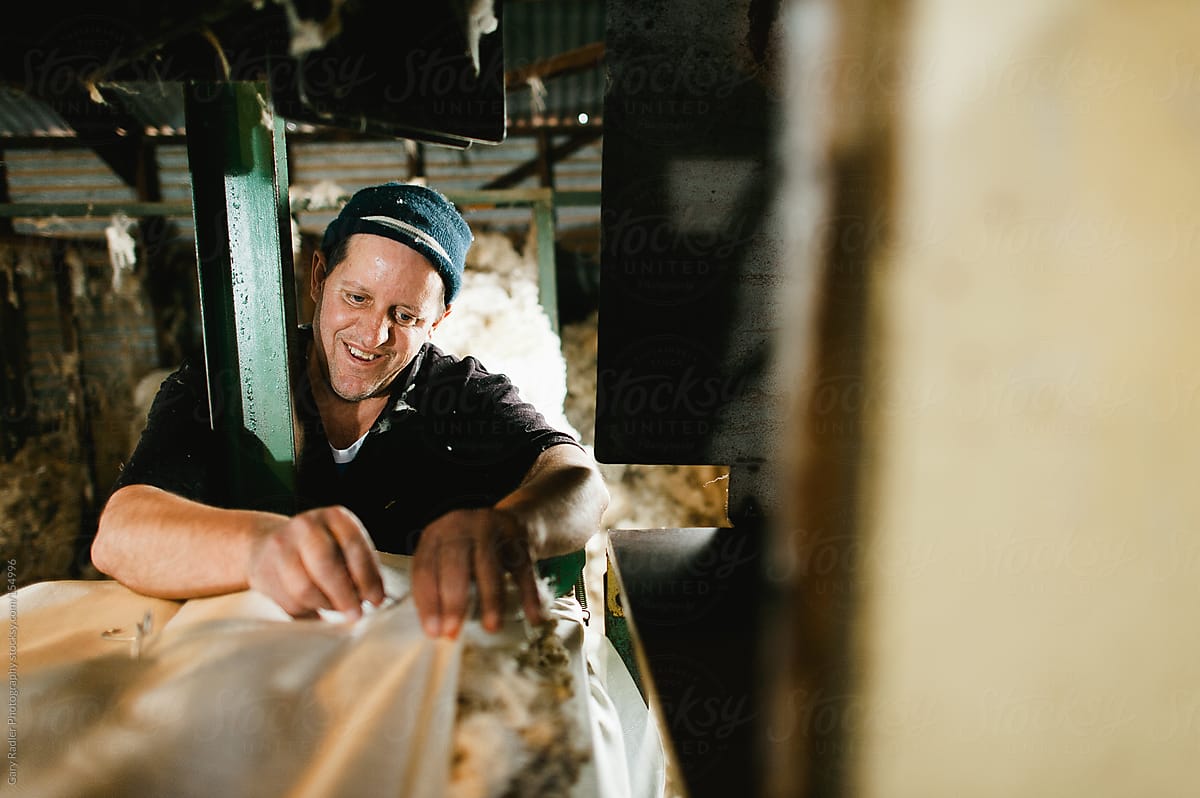 "Farm Worker At Bale Machine In A Wool Shed" by Stocksy Contributor ...
