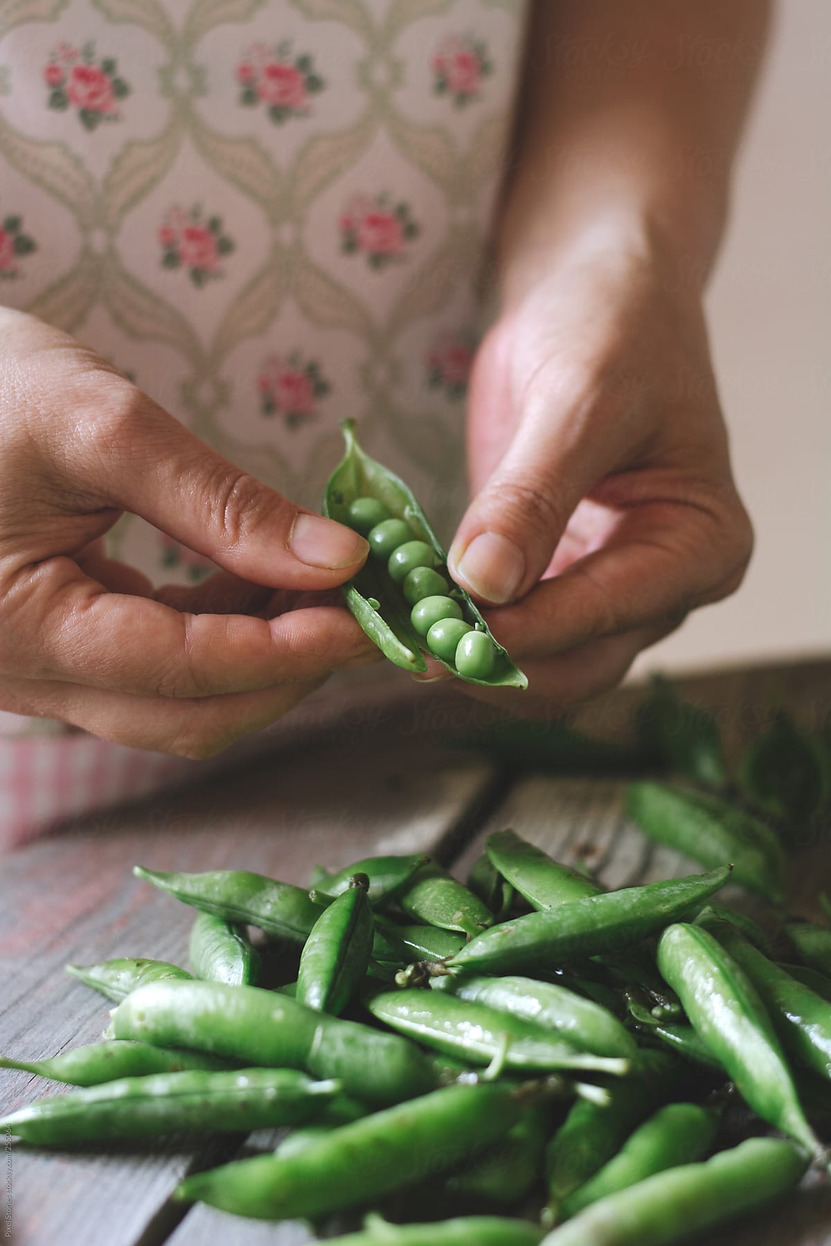 "Podding Fresh Peas" by Stocksy Contributor "Sibila and Pavel" - Stocksy