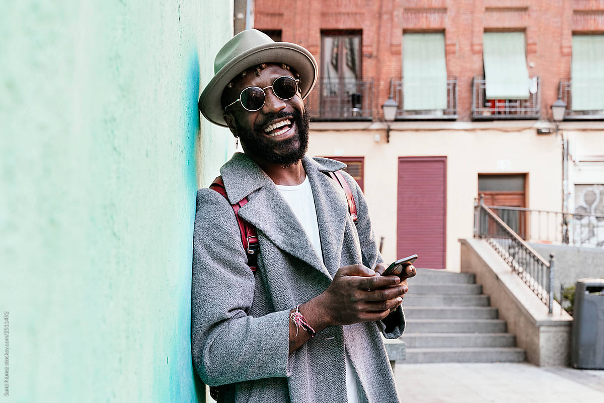 "African Man Using Mobile Phone" by Stocksy Contributor "Santi Nuñez ...