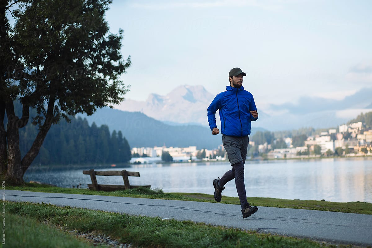 "Man Running Near The Lake" by Stocksy Contributor "Marko" - Stocksy
