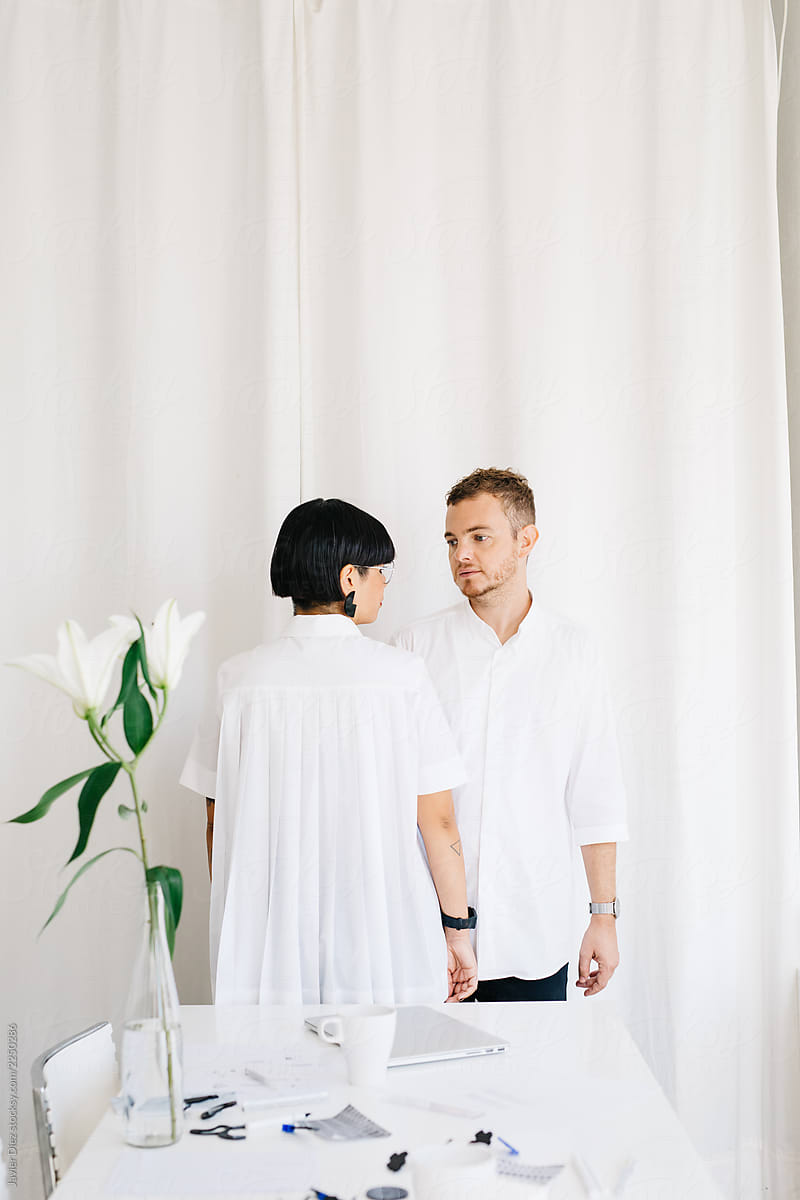 "Young Modern Designers Looking At Each Other In Studio" by Stocksy ...