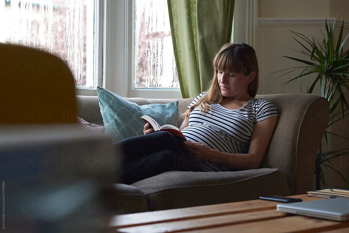 "Reading At Home" by Stocksy Contributor "Jose Coello" - Stocksy