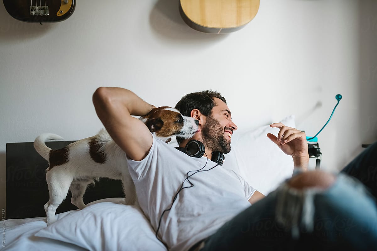 "Happy Man Playing With His Dog At Home" by Stocksy Contributor ...