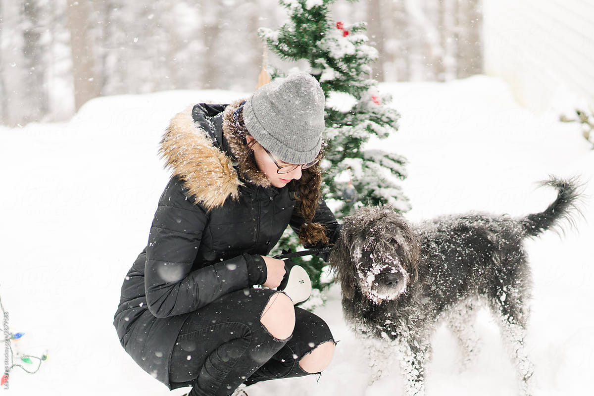 "Teen Girl With Dog In The Snow" by Stocksy Contributor "Lea Jones ...