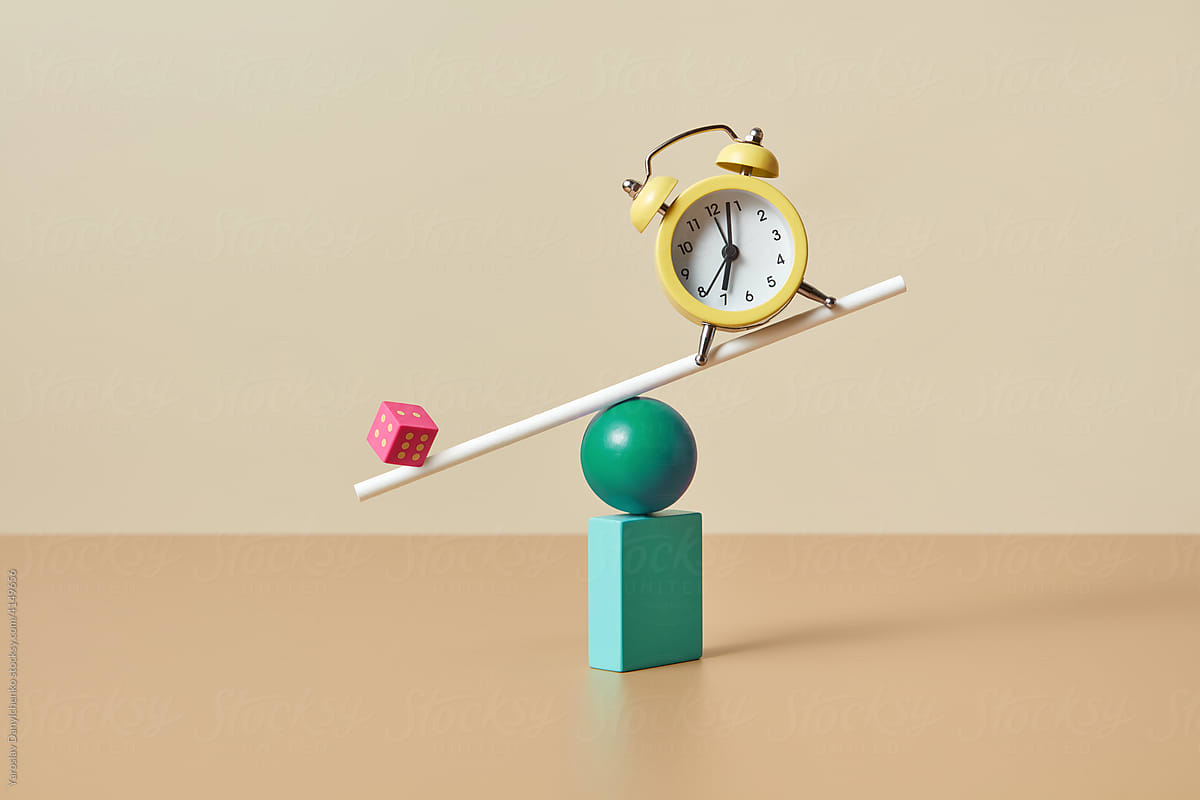 "Dice And Alarm Clock Balancing" by Stocksy Contributor "Yaroslav ...