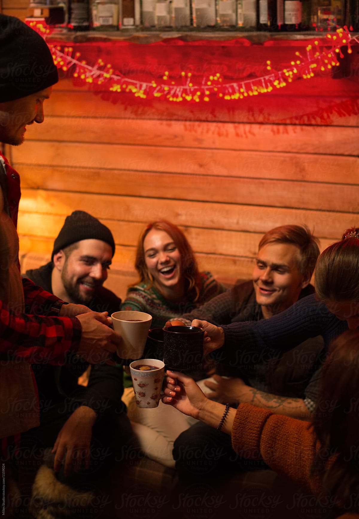 "Friends Raising Toast" by Stocksy Contributor "Milles Team" - Stocksy