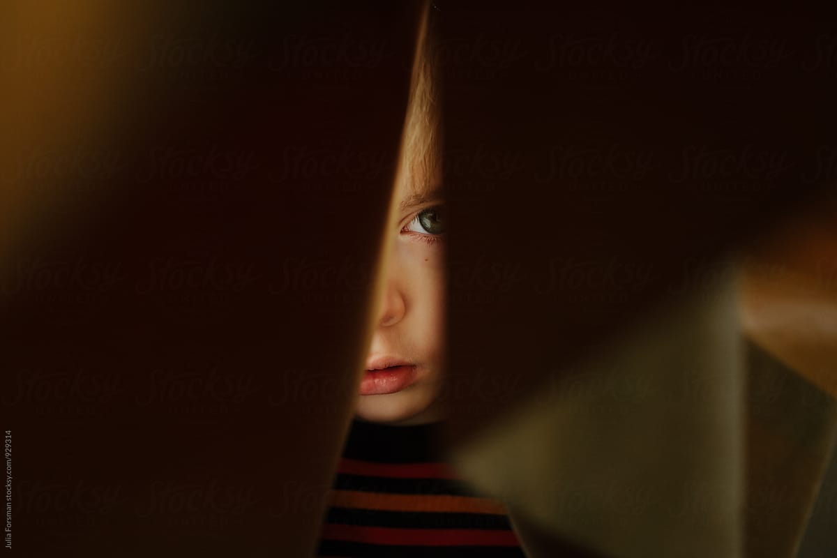 "Close Up Of A Young Boy Hiding Behind A Curtain." by Stocksy ...