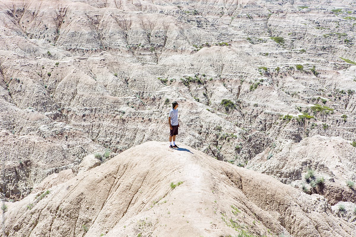 "Man Standing Amongst Dirt Plateaus" by Stocksy Contributor "MEGHAN ...
